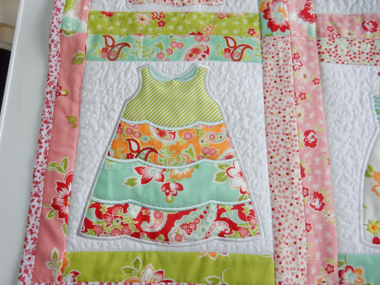 Tiny little dresses: a quilt for a new baby girl – handmade by Carole Carr