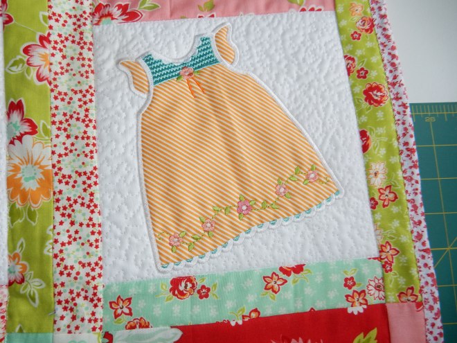 Tiny little dresses: a quilt for a new baby girl – handmade by Carole Carr